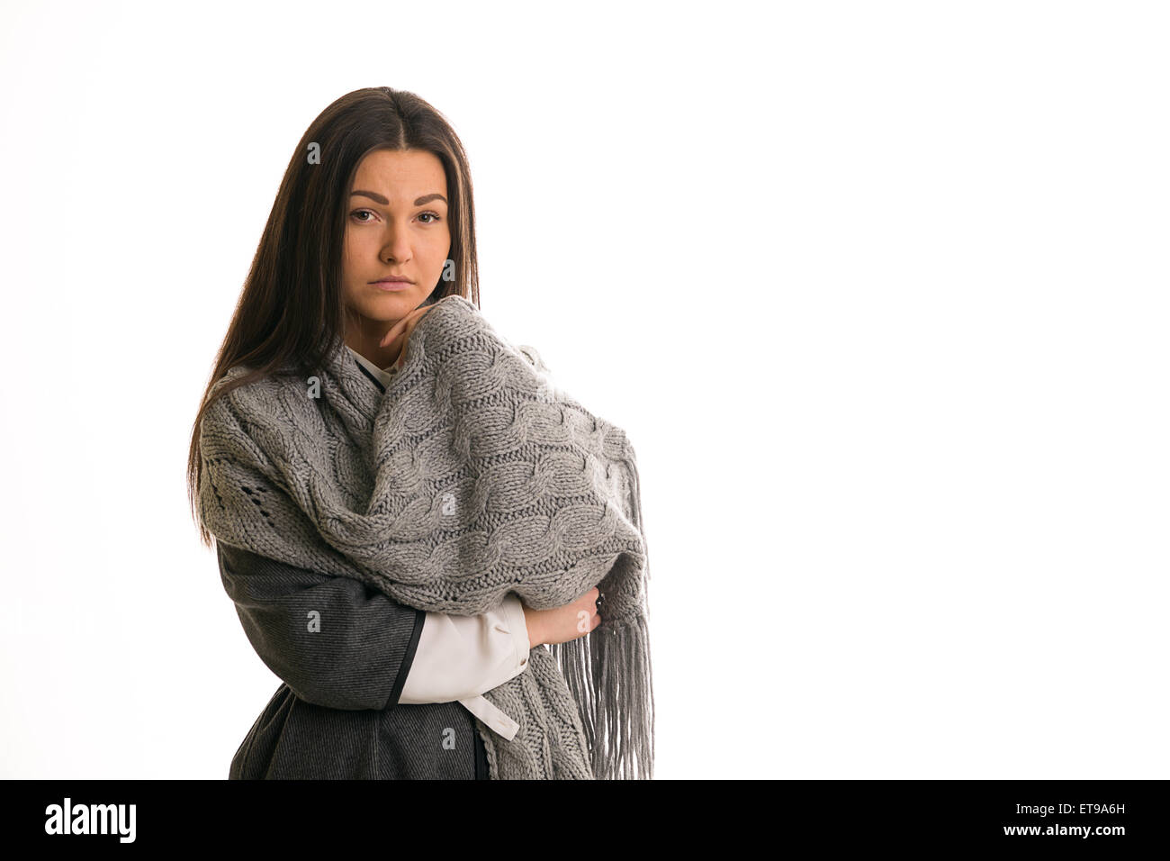 A young woman in a gray knitted scarf sad Stock Photo - Alamy