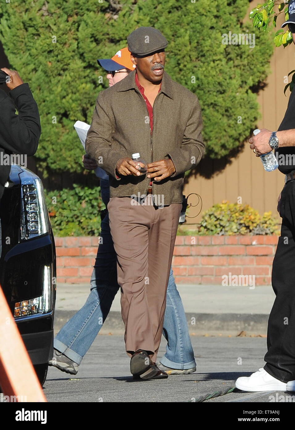 Actor Eddie Murphy sports a grey mustache and 70's attire on the set of ...