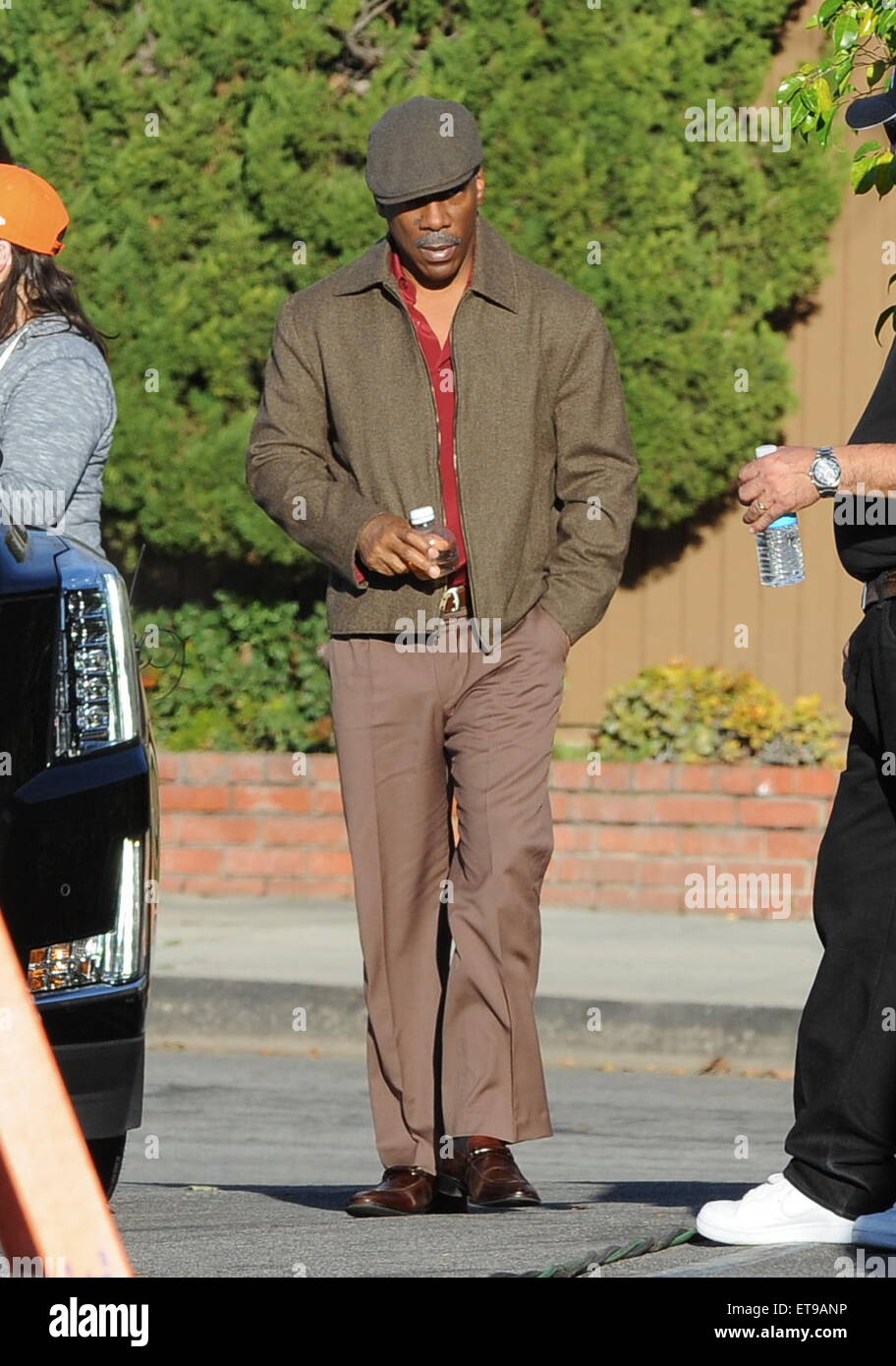 Actor Eddie Murphy sports a grey mustache and 70's attire on the set of ...