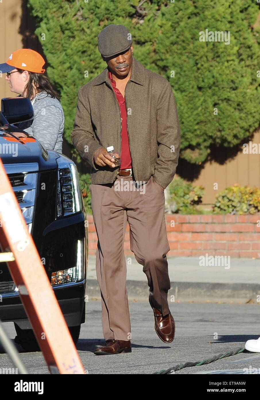 Actor Eddie Murphy sports a grey mustache and 70's attire on the set of ...