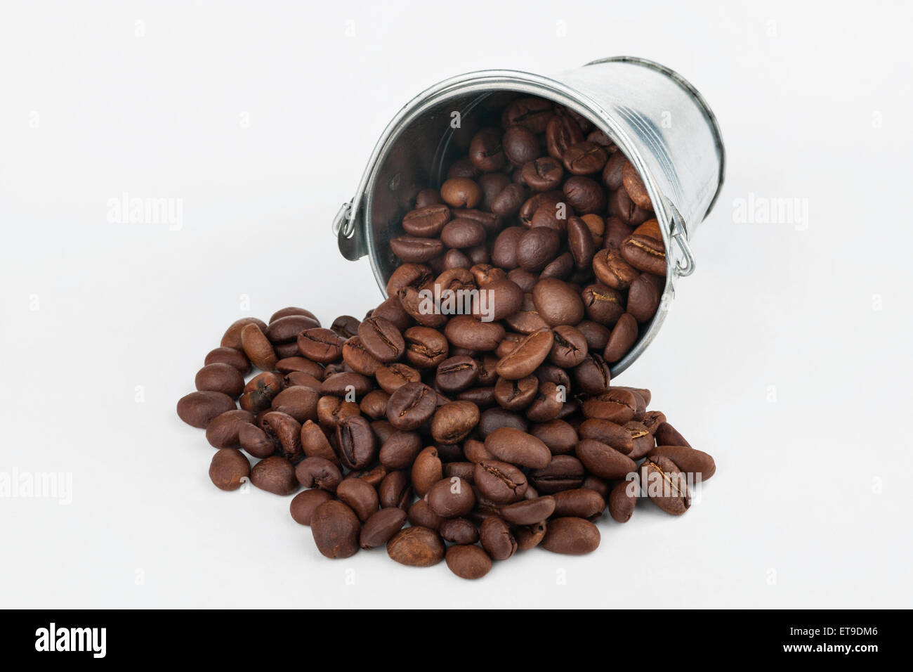 Coffee beans spilling out of bucket, on a white background Stock Photo ...