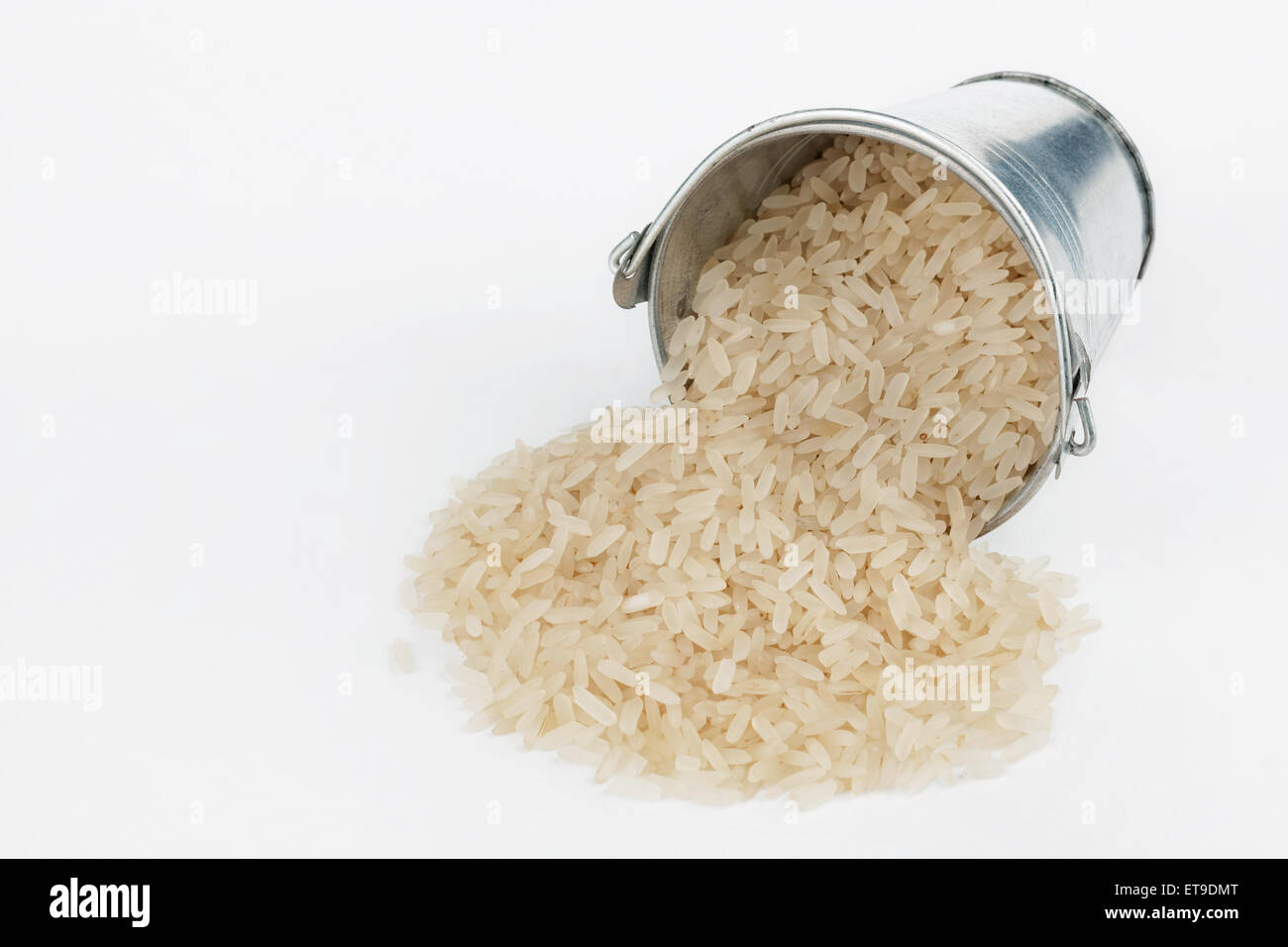 Rice grains spilling out of bucket, on a white background Stock Photo ...
