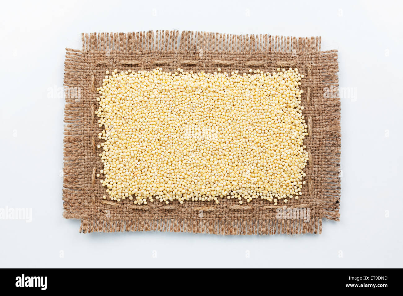 Classical frame made of burlap with grains of millet, on a white ...