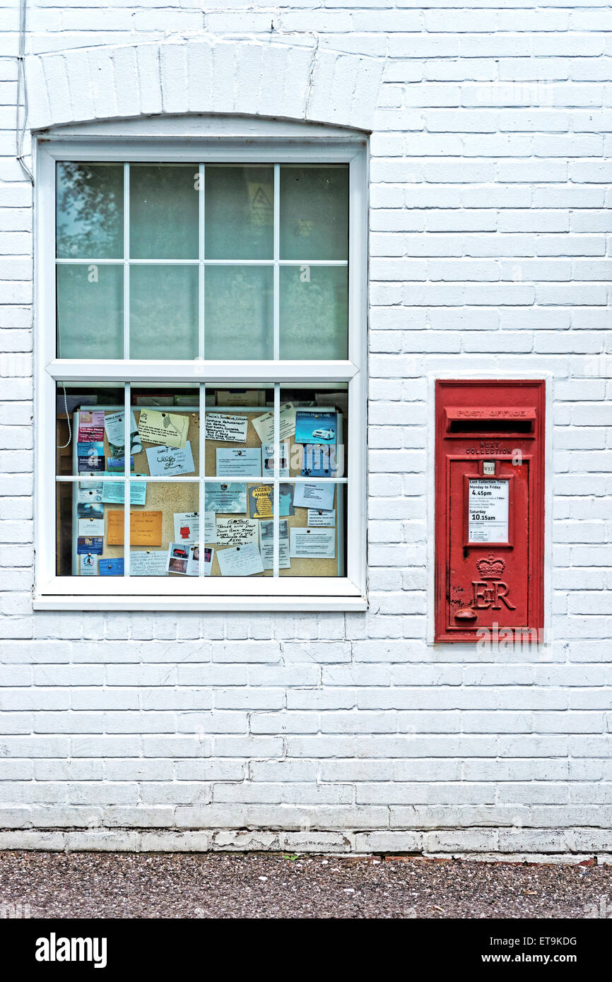 Red postbox outside village store Stock Photo - Alamy
