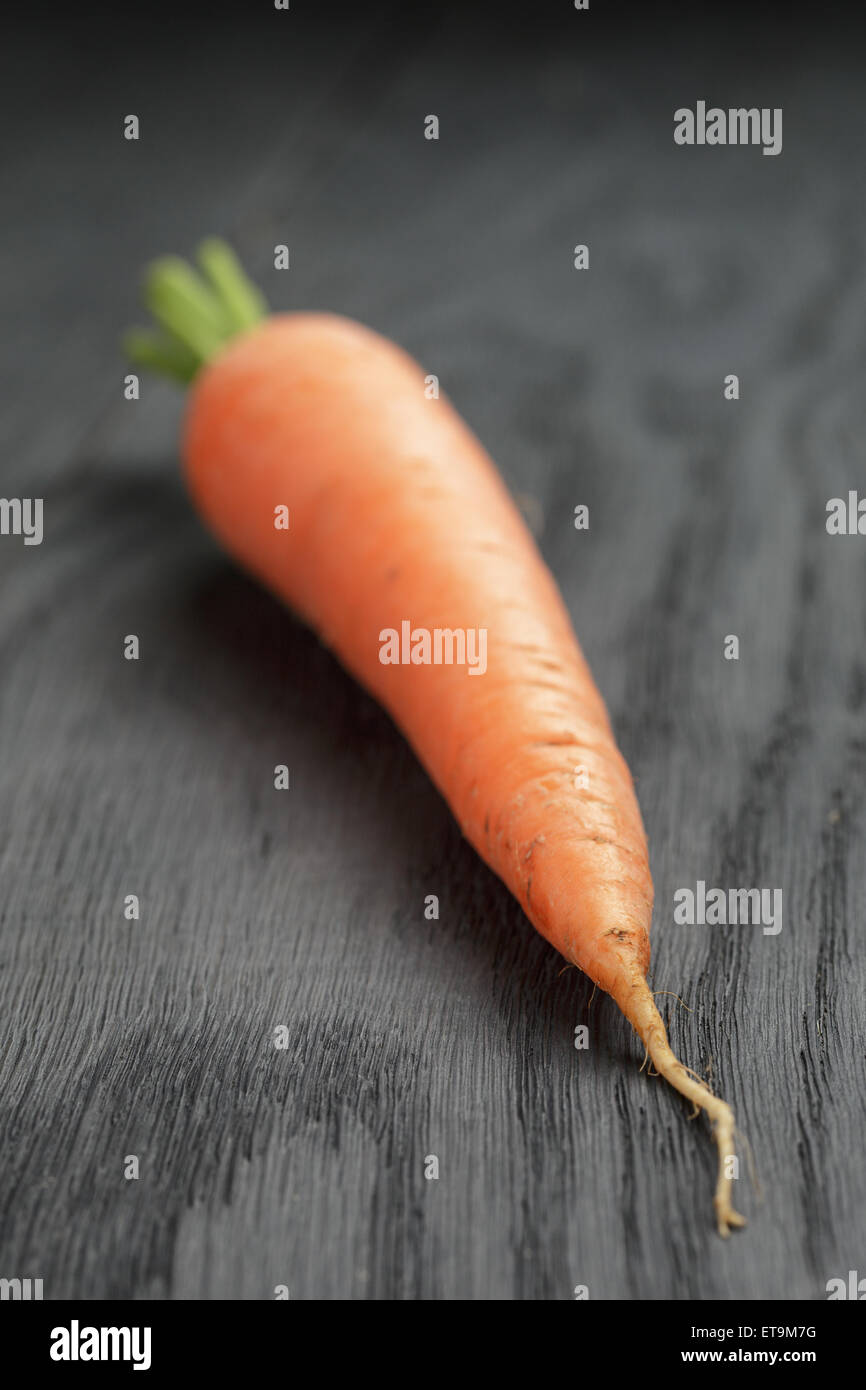 fresh carrot on old oak table Stock Photo - Alamy