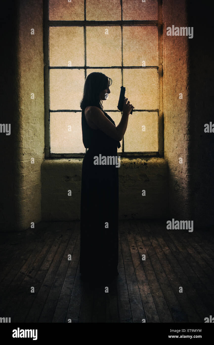 Woman holding gun hi-res stock photography and images - Alamy