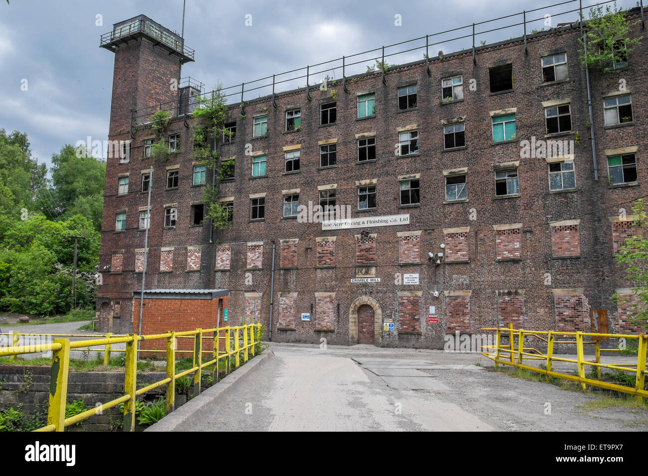 A Disused factory which has bricked up windows and door to the second ...