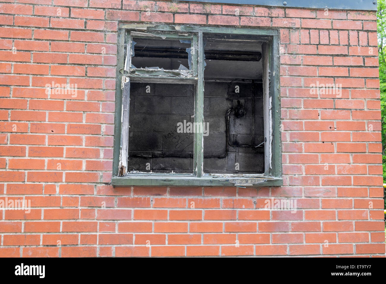 Broken window in an abandoned security office outside an abandoned and ...