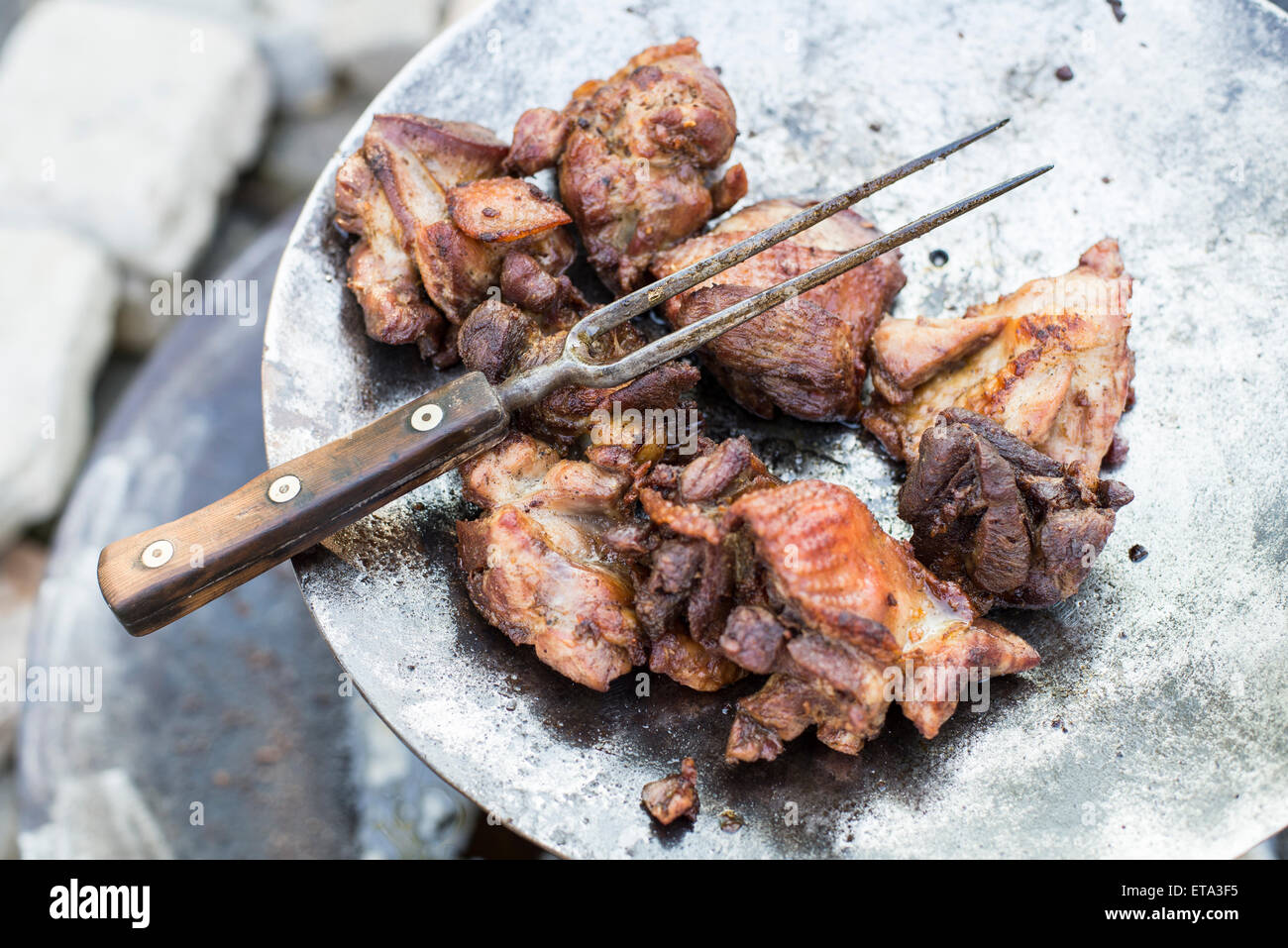 Fried turkey meat on large metal frying pan with a fork Stock Photo - Alamy