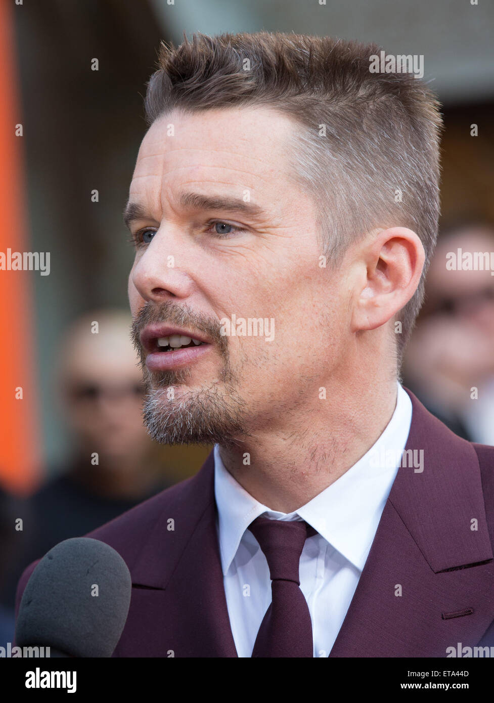 Actor Ethan Hawke places handprints and footprints in cement during his ...
