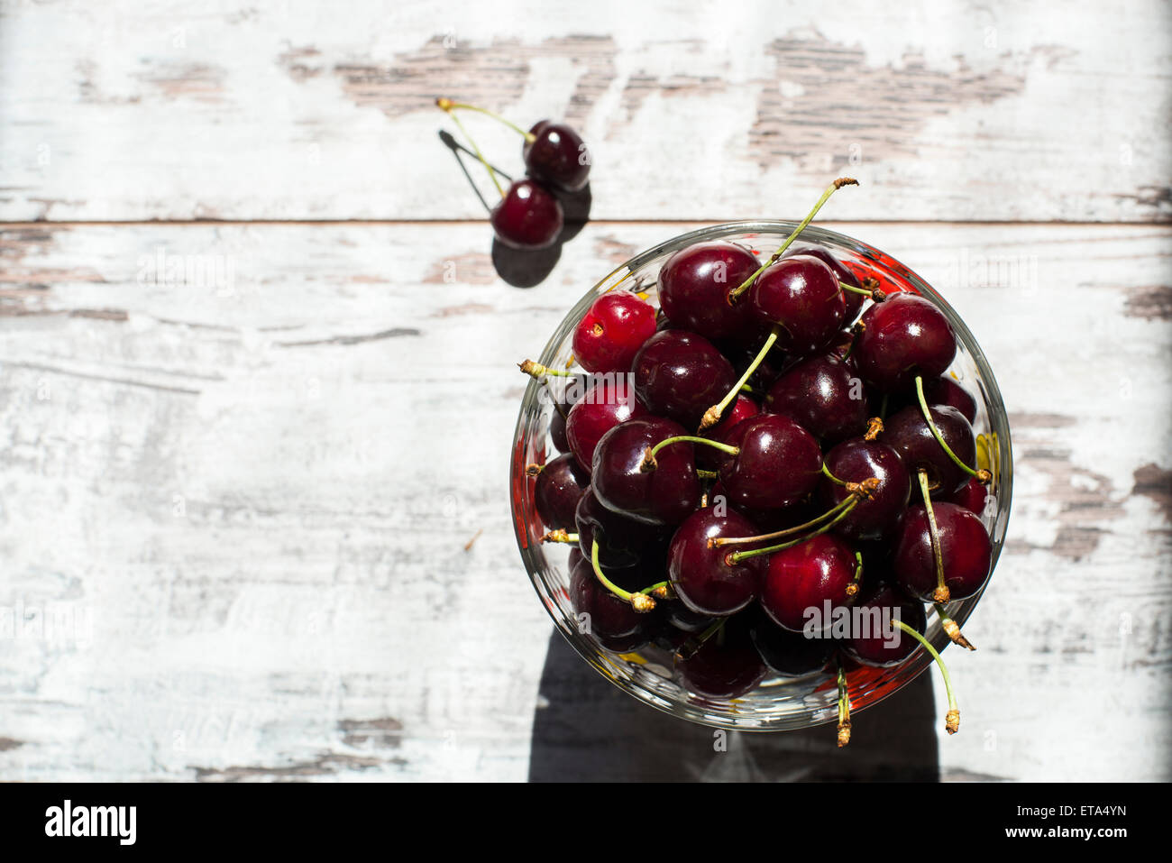 Dark red sweet cherries in transparent bowl top view Stock Photo - Alamy