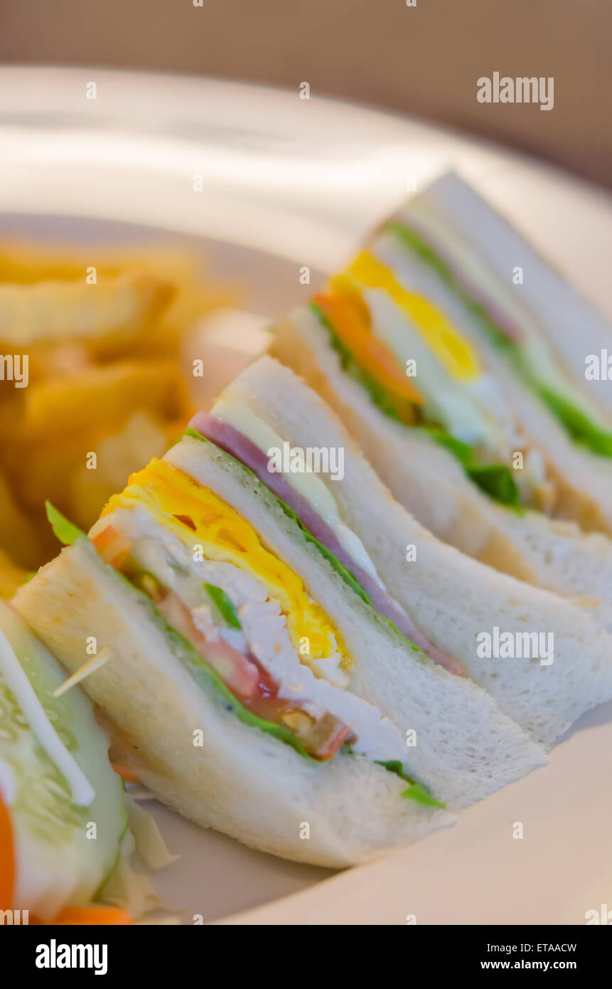 Delicious club sandwich with french fries at a dinner Stock Photo - Alamy