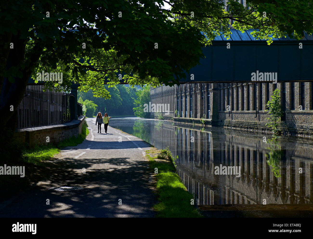 Two girls walking on towpath of Leeds and Liverpool Canal, and Salt's ...