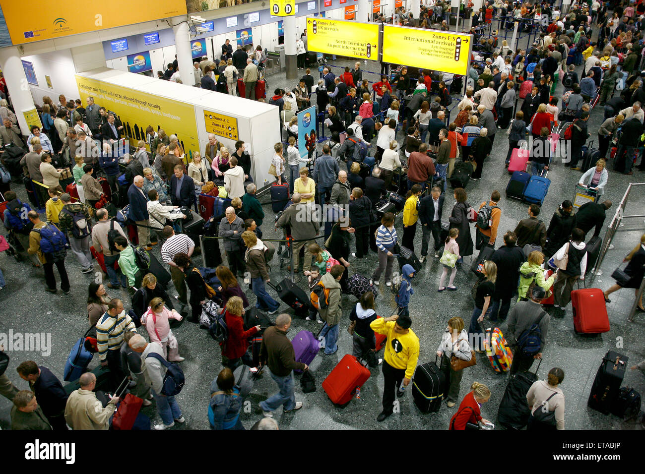 Travelers in the South terminal of London's Gatwick Airport queue to ...