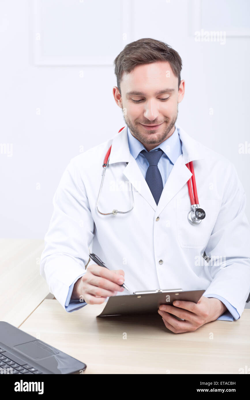 Nice doctor filling the papers Stock Photo - Alamy