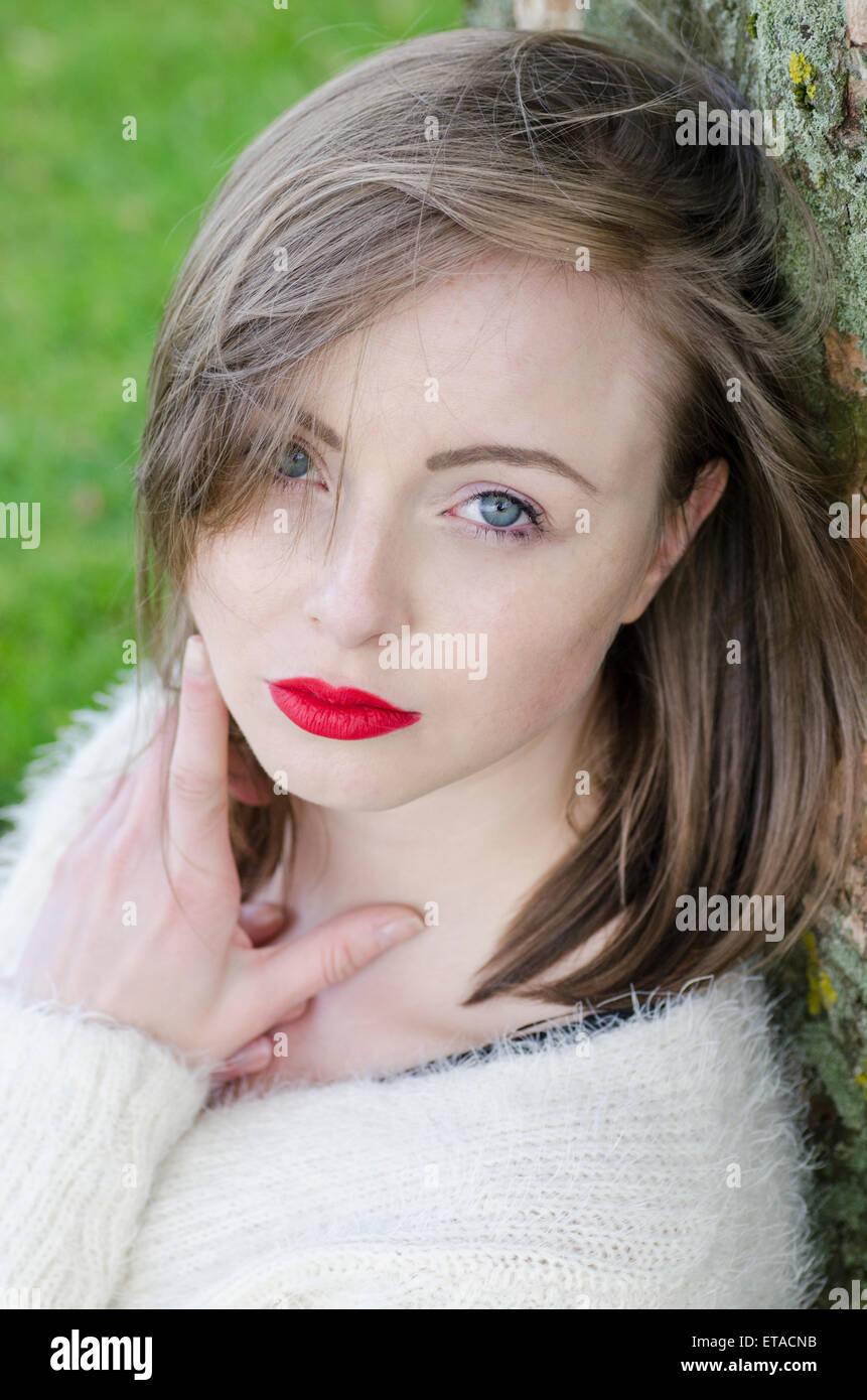 Beautiful young woman hands over heart Stock Photo - Alamy