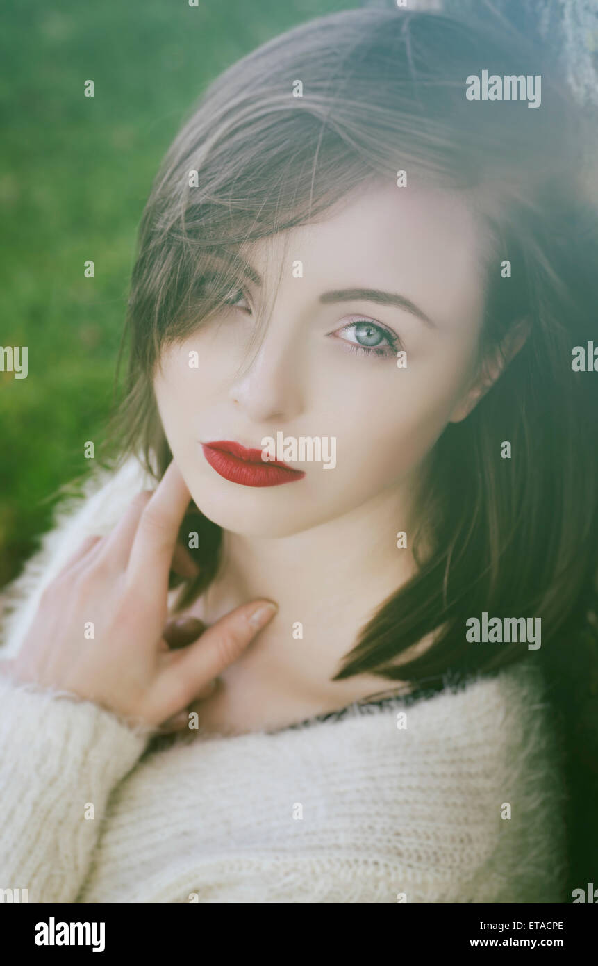 Beautiful young woman hands over heart Stock Photo - Alamy