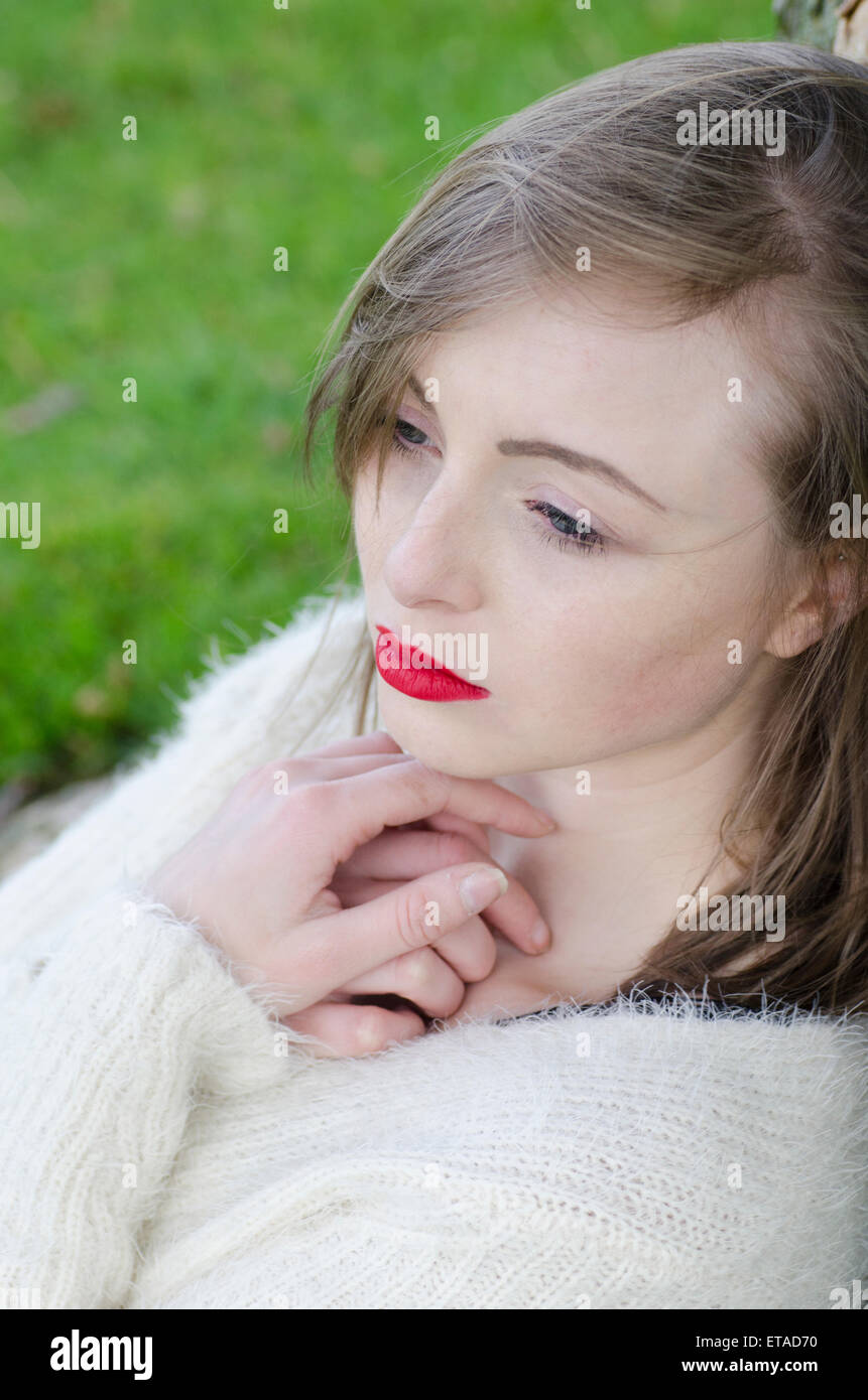 Beautiful young woman hands over heart Stock Photo - Alamy