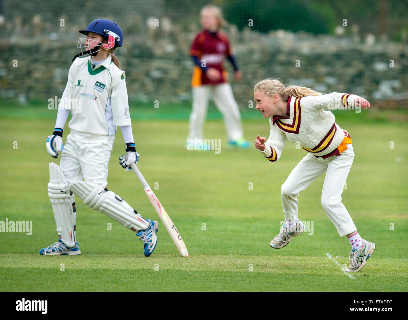 A bowler during a junior girls cricket match in Wiltshire UK Stock ...