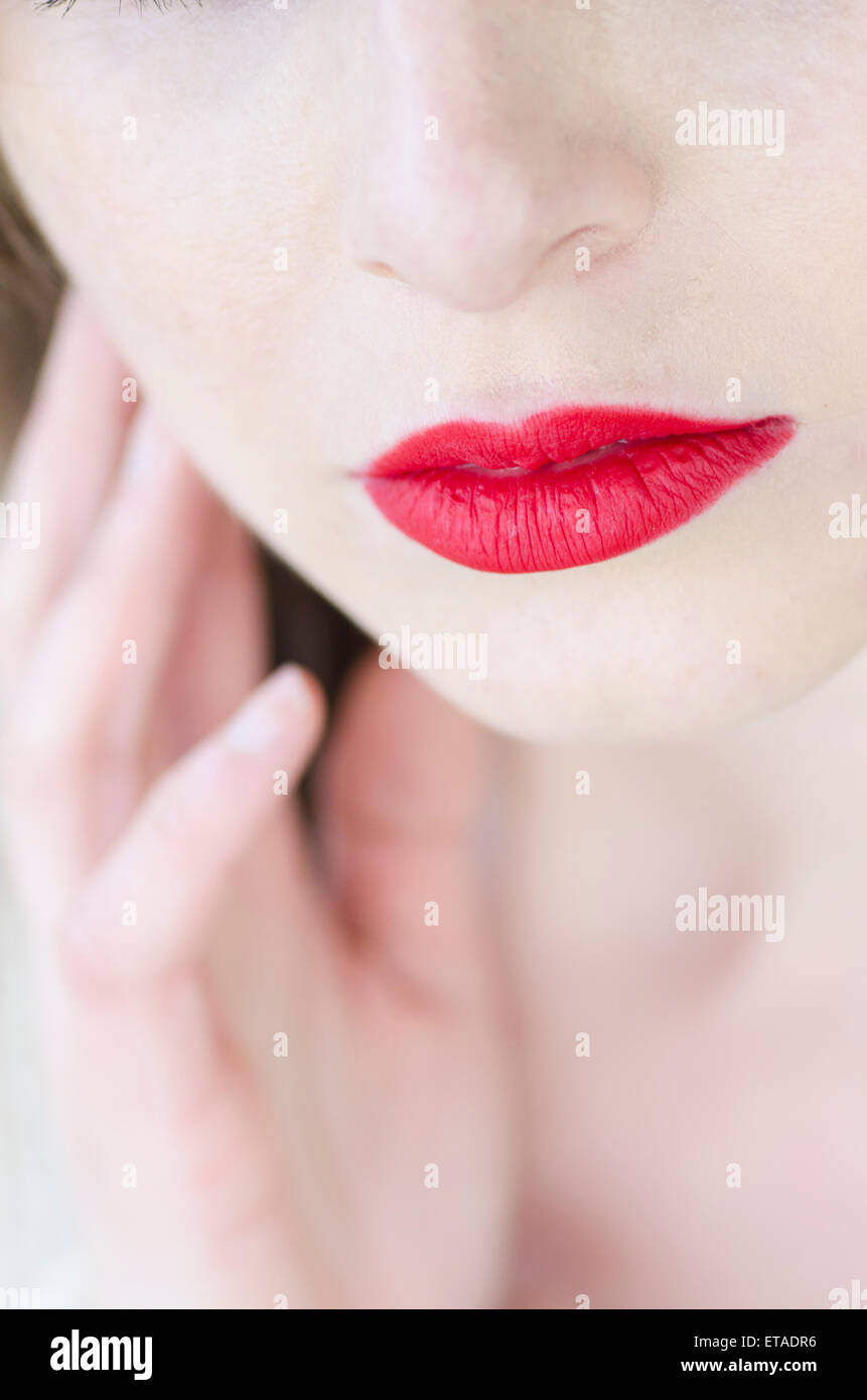 Closeup of a young woman's lips with hand touching face Stock Photo - Alamy