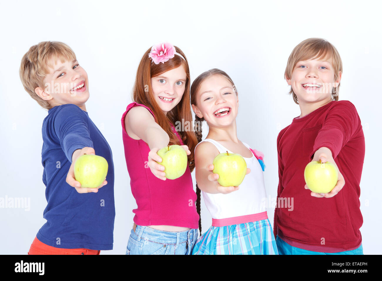 Positive friends keeping apples Stock Photo - Alamy