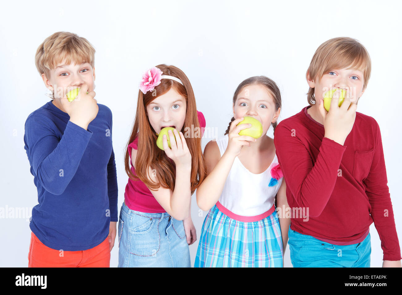 Positive friends keeping apples Stock Photo - Alamy