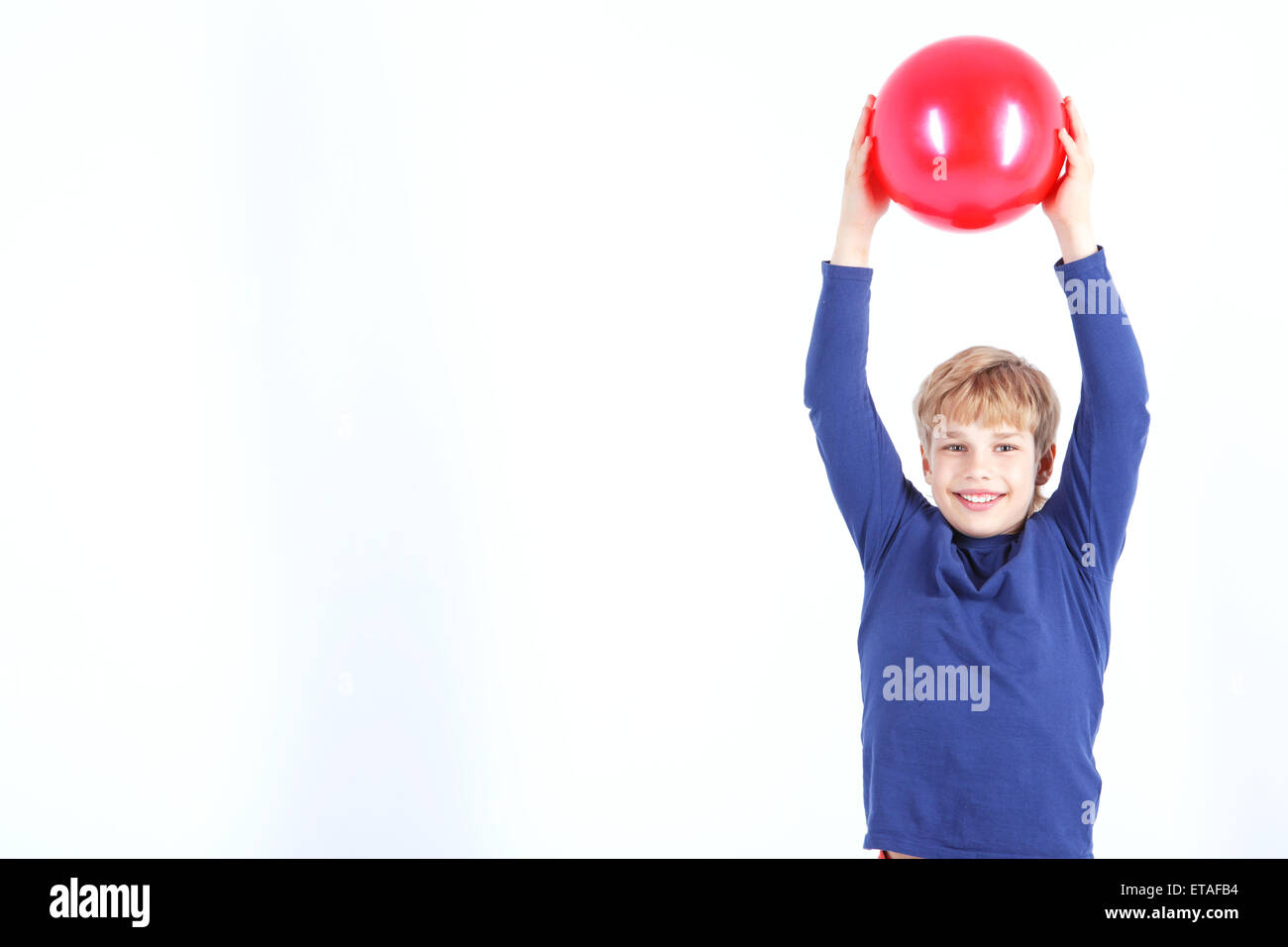 Cheerful boy holding the ball Stock Photo - Alamy