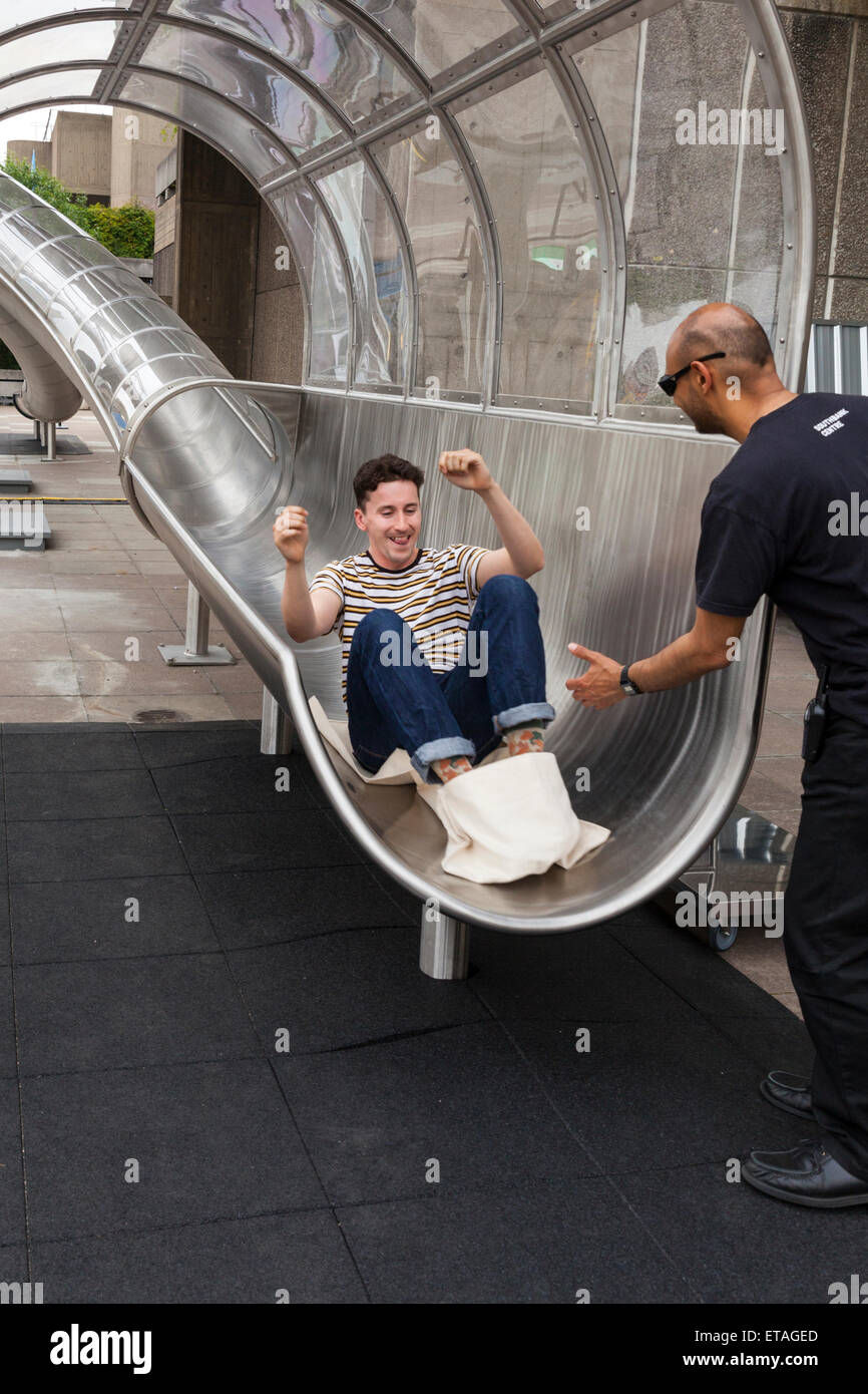 London, UK. 12th June 2015. Londoners have fun sliding down the steep ...