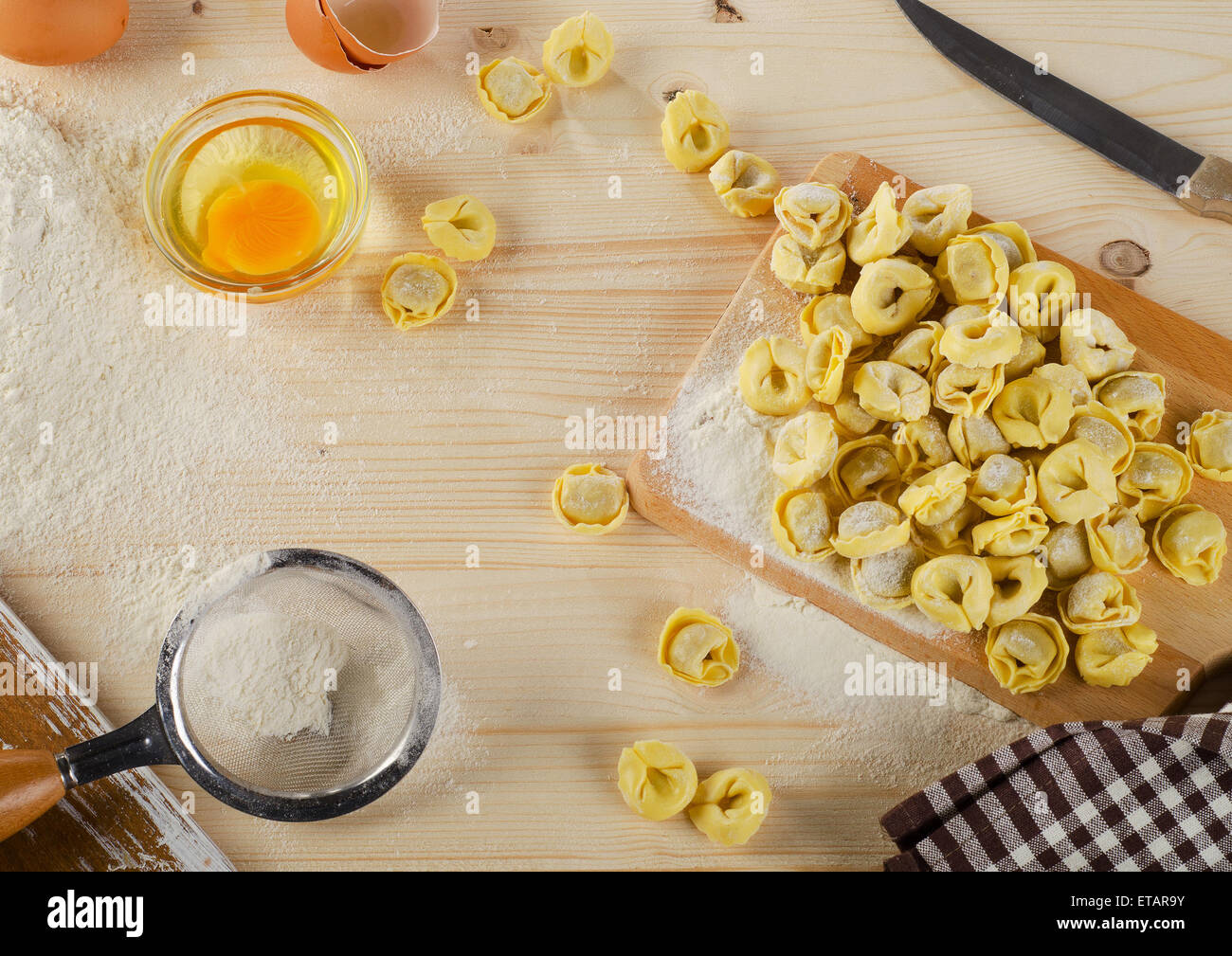 Uncooked italian Ravioli on a wooden board.Top view Stock Photo - Alamy