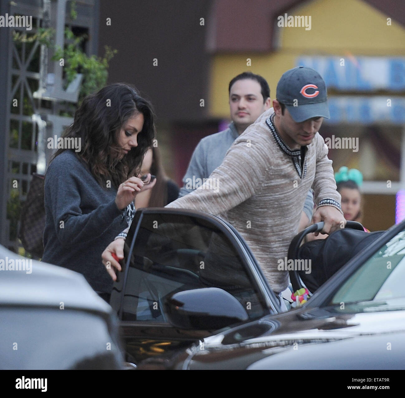 Ashton Kutcher heads for his car carrying baby Wyatt in a sleeper as he ...