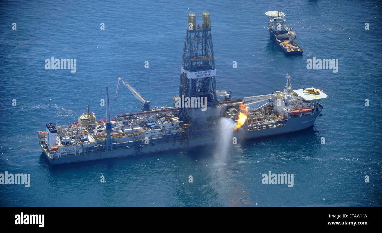 Gas from the damaged Deepwater Horizon wellhead is burned off by the ...
