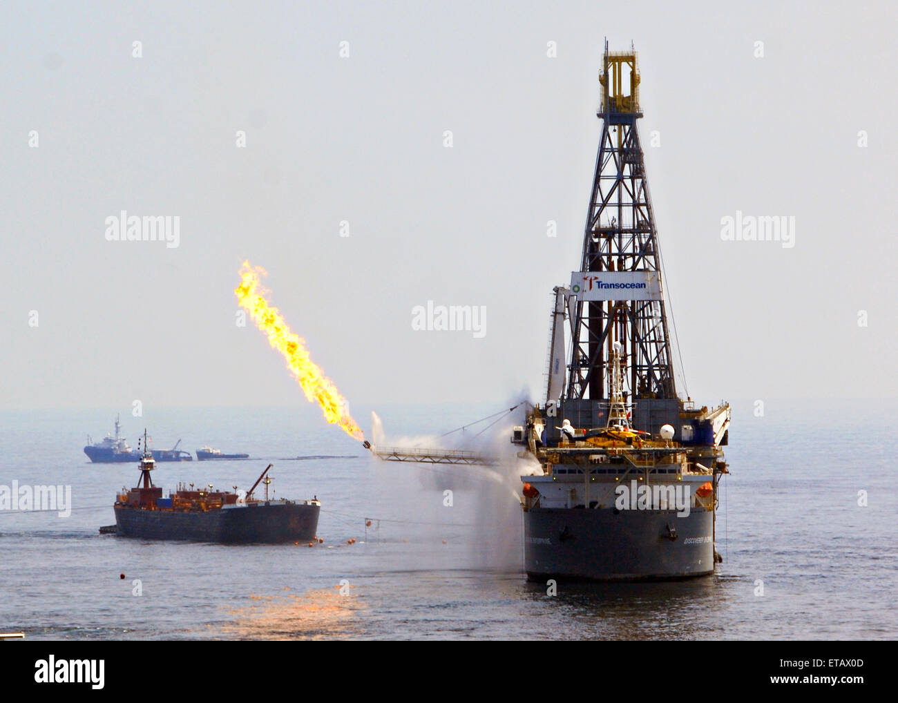 Gas from the damaged Deepwater Horizon wellhead is burned off by the ...