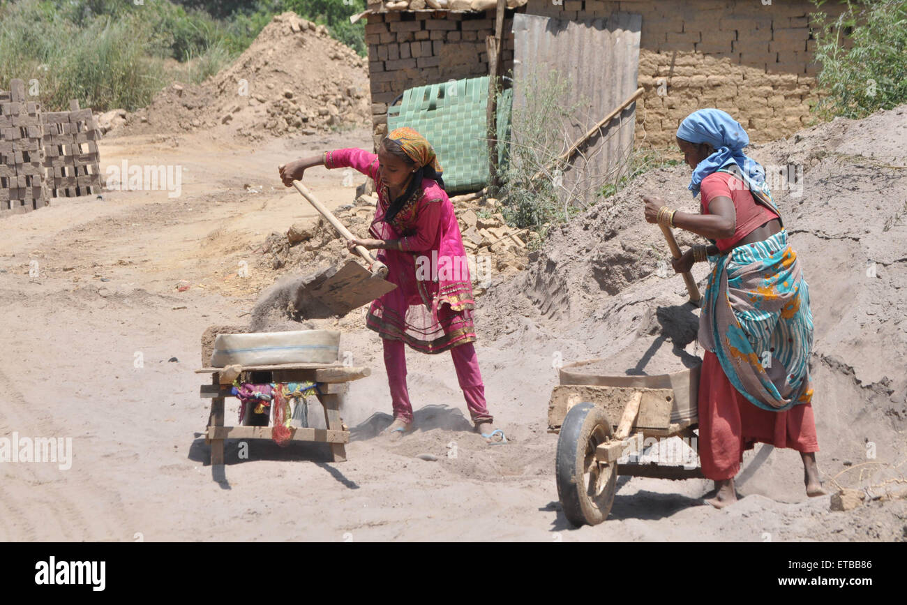 India. 11th June, 2015. Indian children work at a brick kiln in ...