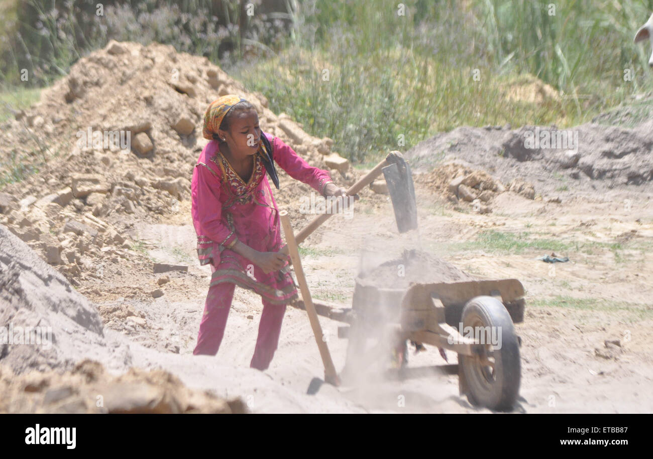 India. 11th June, 2015. An Indian girl, Kavita (12 years old ), works ...