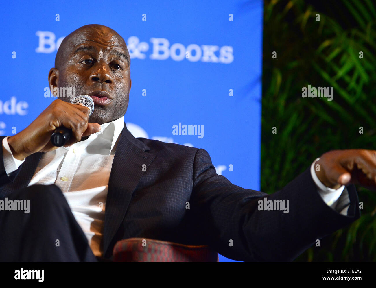 Mike Fernandez is joined by NBA legend Magic Johnson at a presentation ...