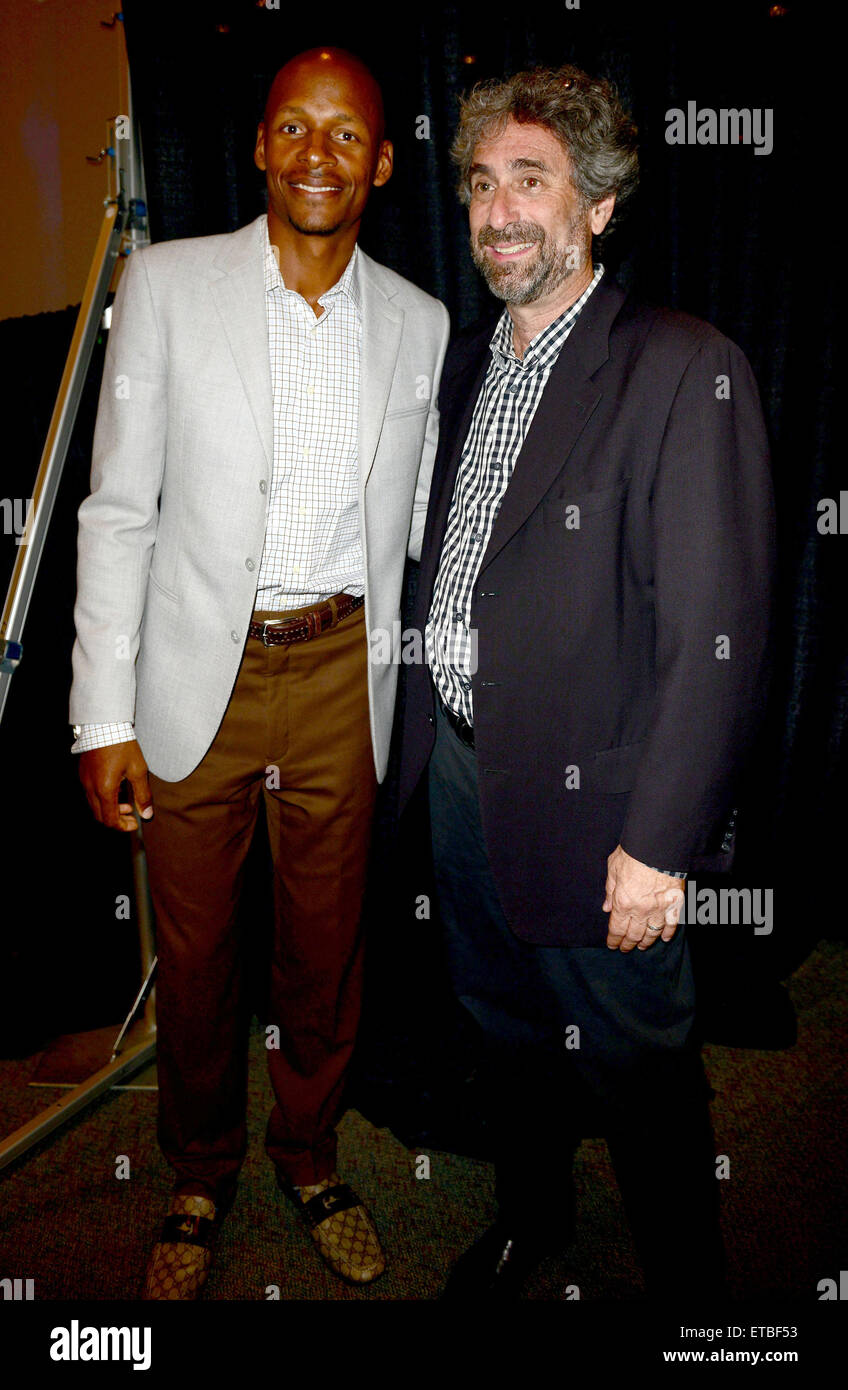 Mike Fernandez is joined by NBA legend Magic Johnson at a presentation ...
