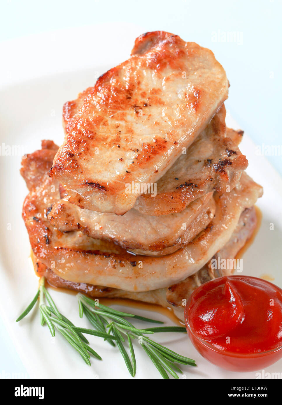 Stack of pork cutlets and tomato dip Stock Photo - Alamy