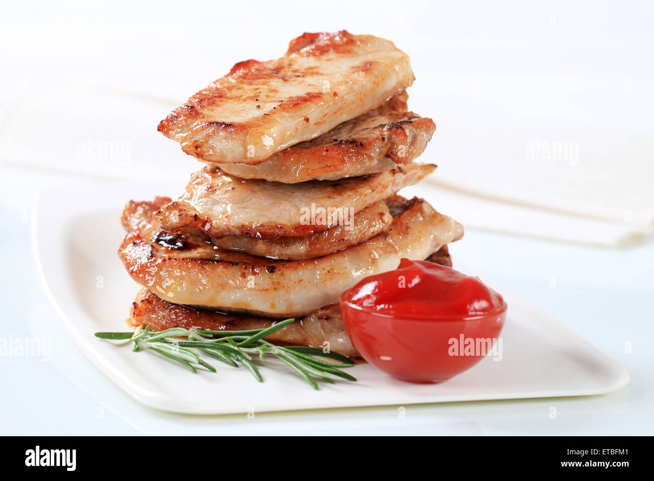 Stack of pork cutlets and tomato dip Stock Photo - Alamy