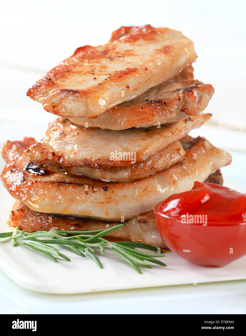 Stack of pork cutlets and tomato dip Stock Photo - Alamy