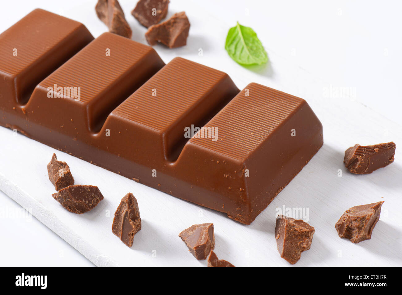 chocolate bar on white cutting board Stock Photo - Alamy