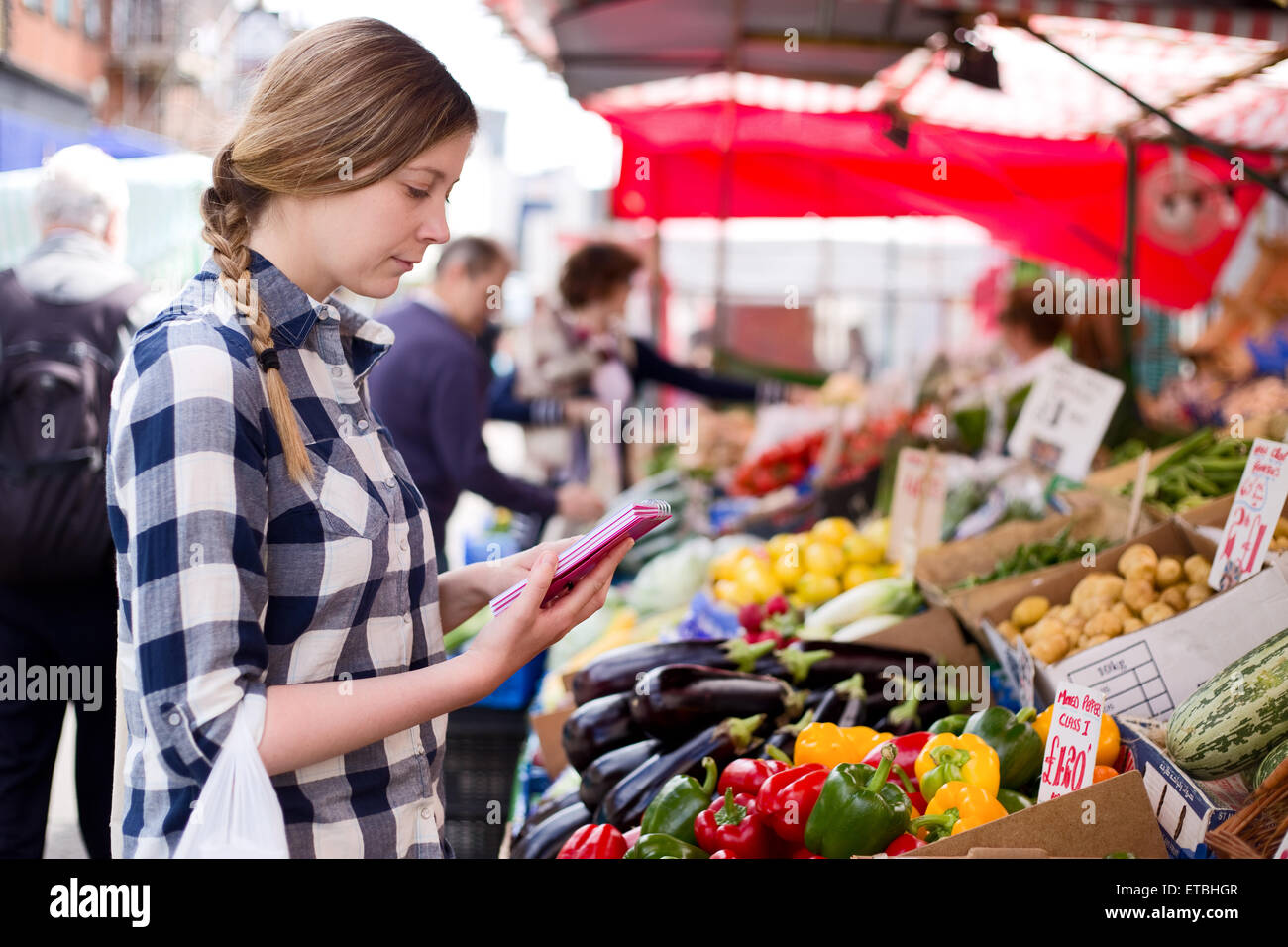 young woman reading her shopping list at the market Stock Photo - Alamy