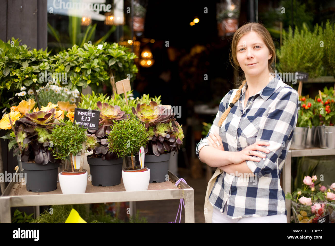 business woman standing outside her flower shop Stock Photo - Alamy