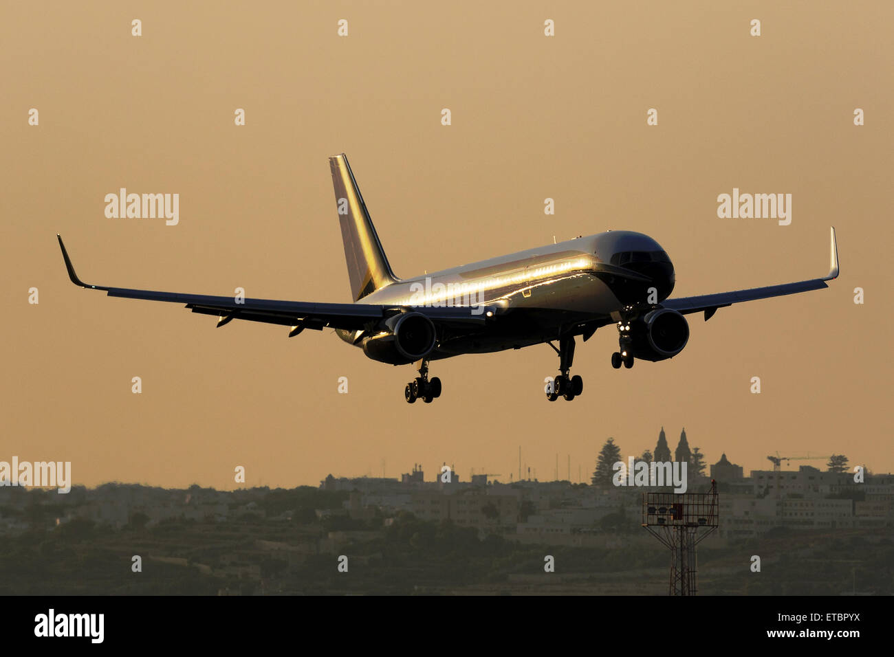 A private Boeing 757 (M-RISE) landing in the late evening Stock Photo ...