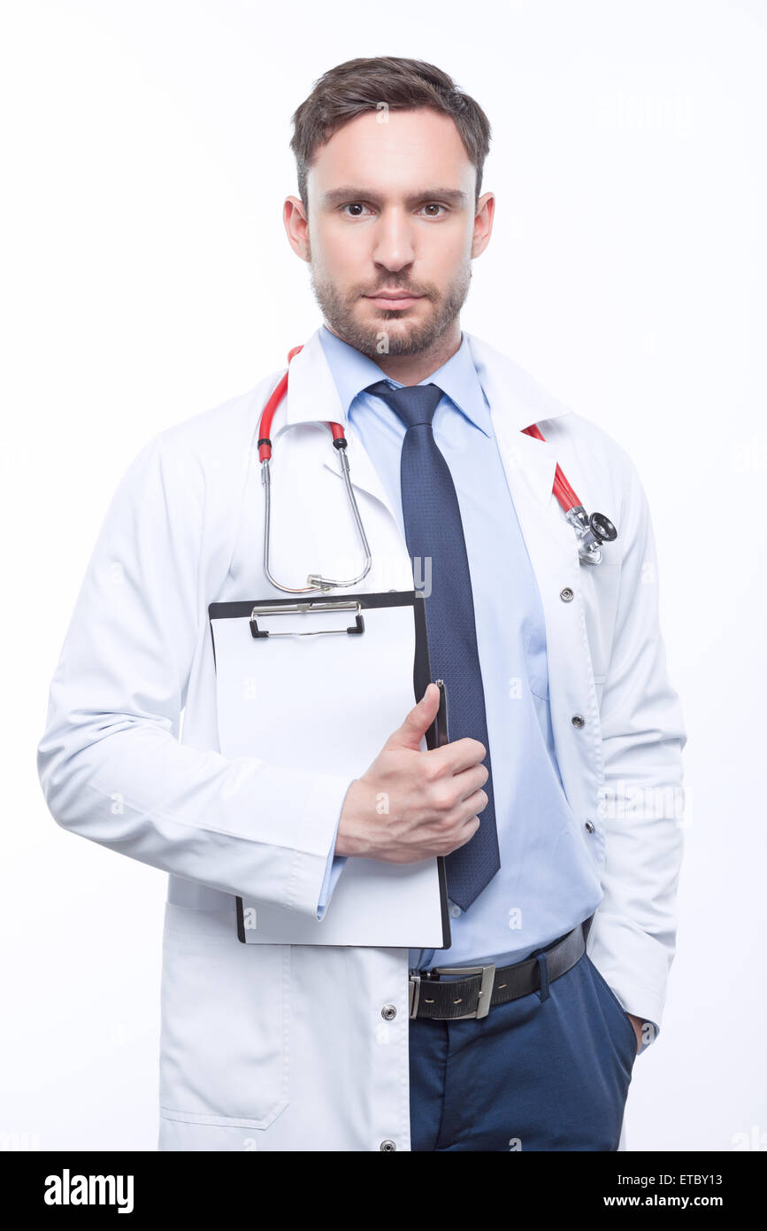Thoughtful doctor holding papers Stock Photo - Alamy