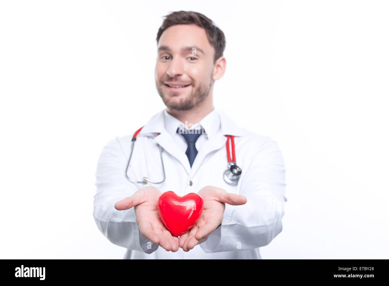 Nice cardiologist holding heart Stock Photo - Alamy