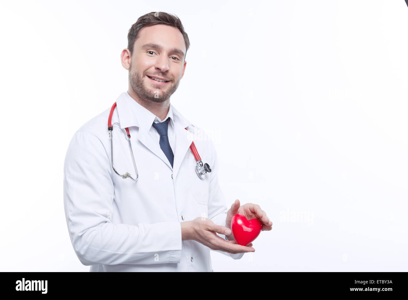 Nice cardiologist holding heart Stock Photo - Alamy