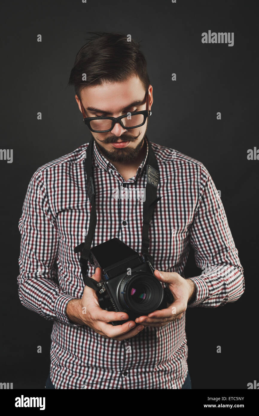handsome guy with beard holding vintage camera Stock Photo - Alamy