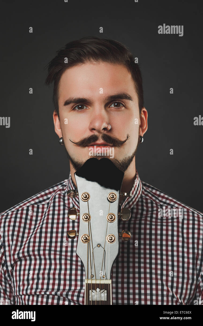 handsome guy with beard holding acoustic guitar Stock Photo - Alamy