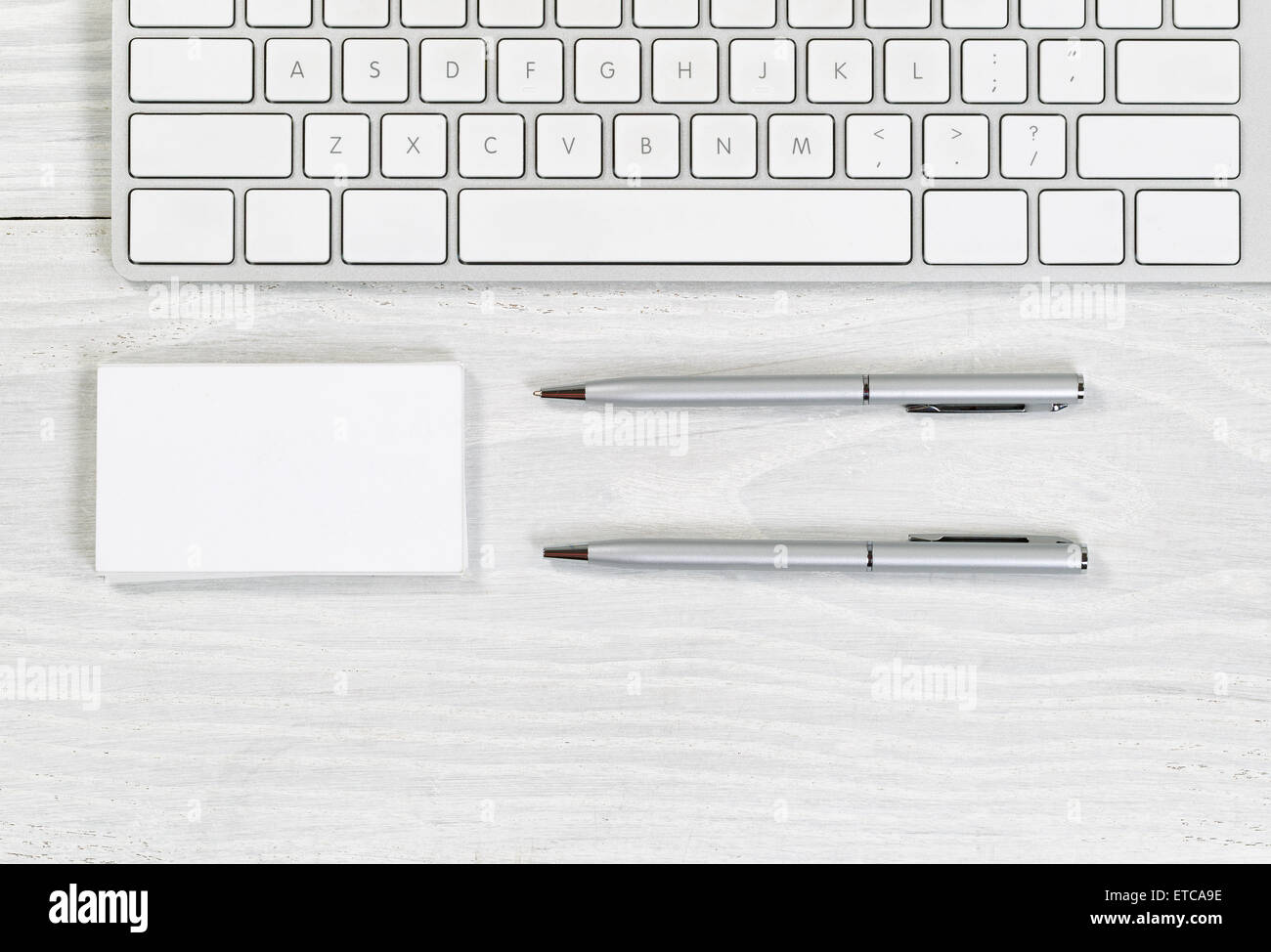 Image of partial keyboard, stack of blank business cards, and silver ...