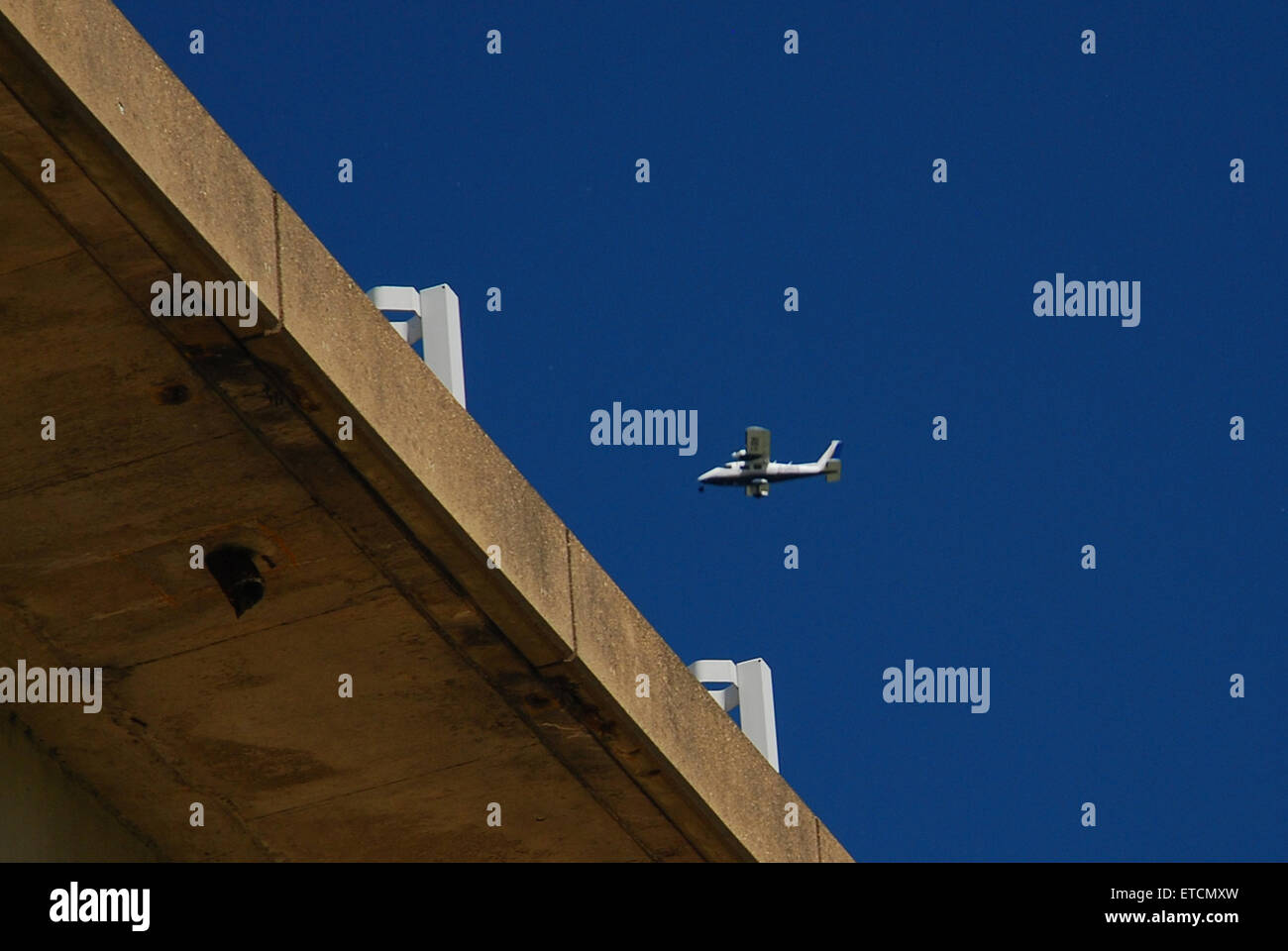 Plane over M56 motorway near Frodsham in Cheshire. Blue sky overhead ...